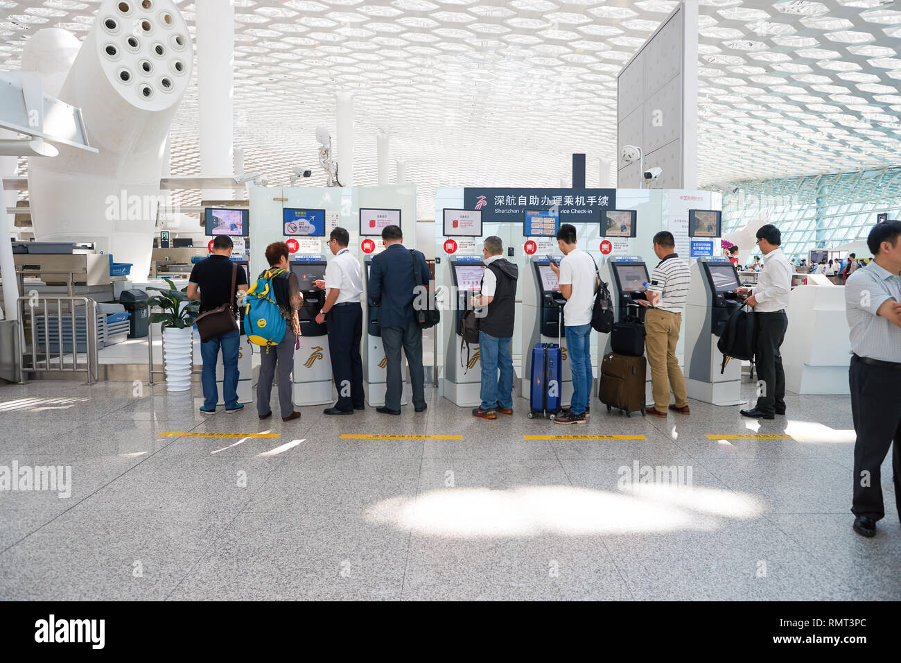 SHENZHEN, CHINA - CIRCA MAY, 2016: people use self check-in kiosks in ...