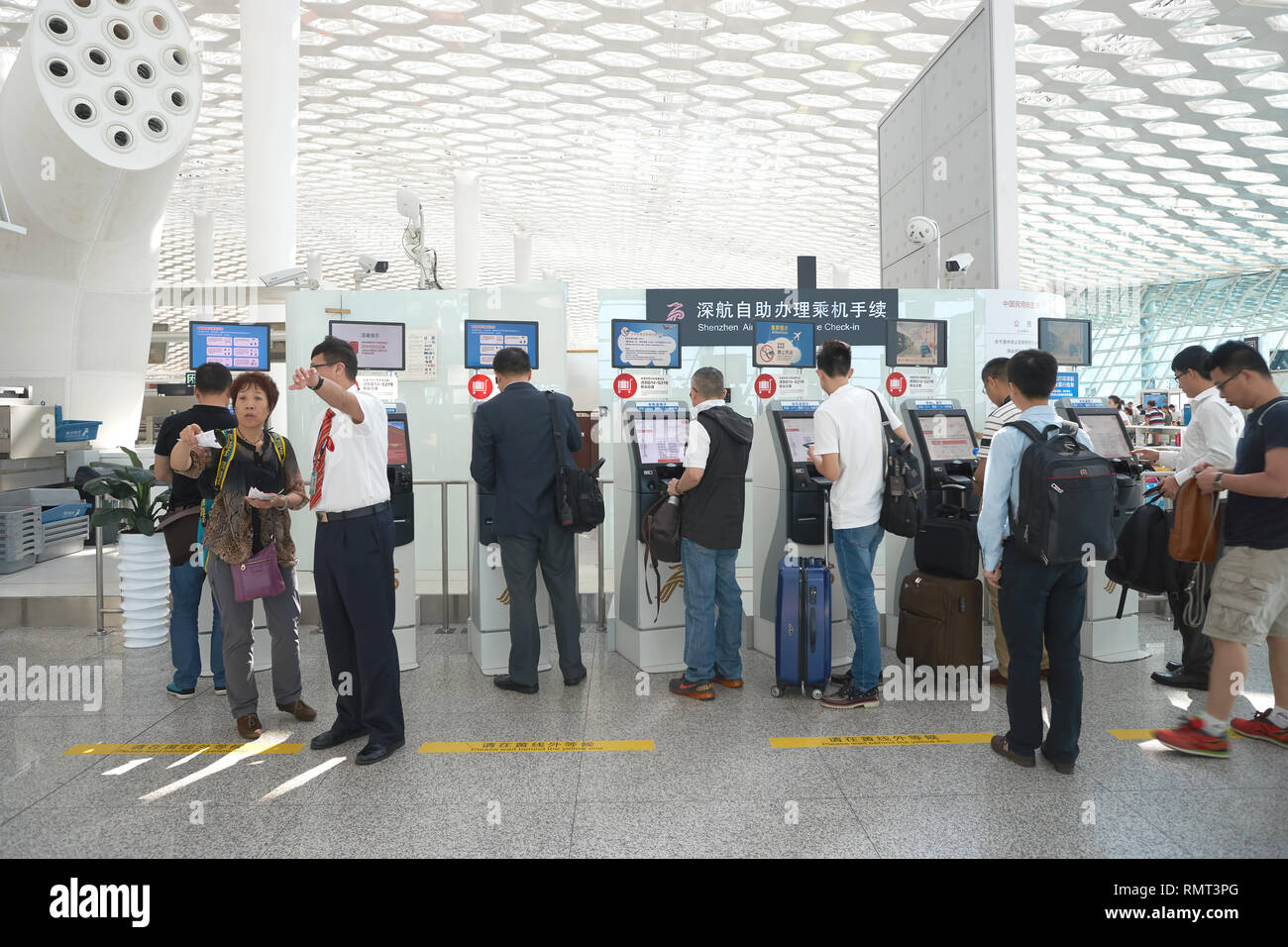 SHENZHEN, CHINA - CIRCA MAY, 2016: people use self check-in kiosks in ...