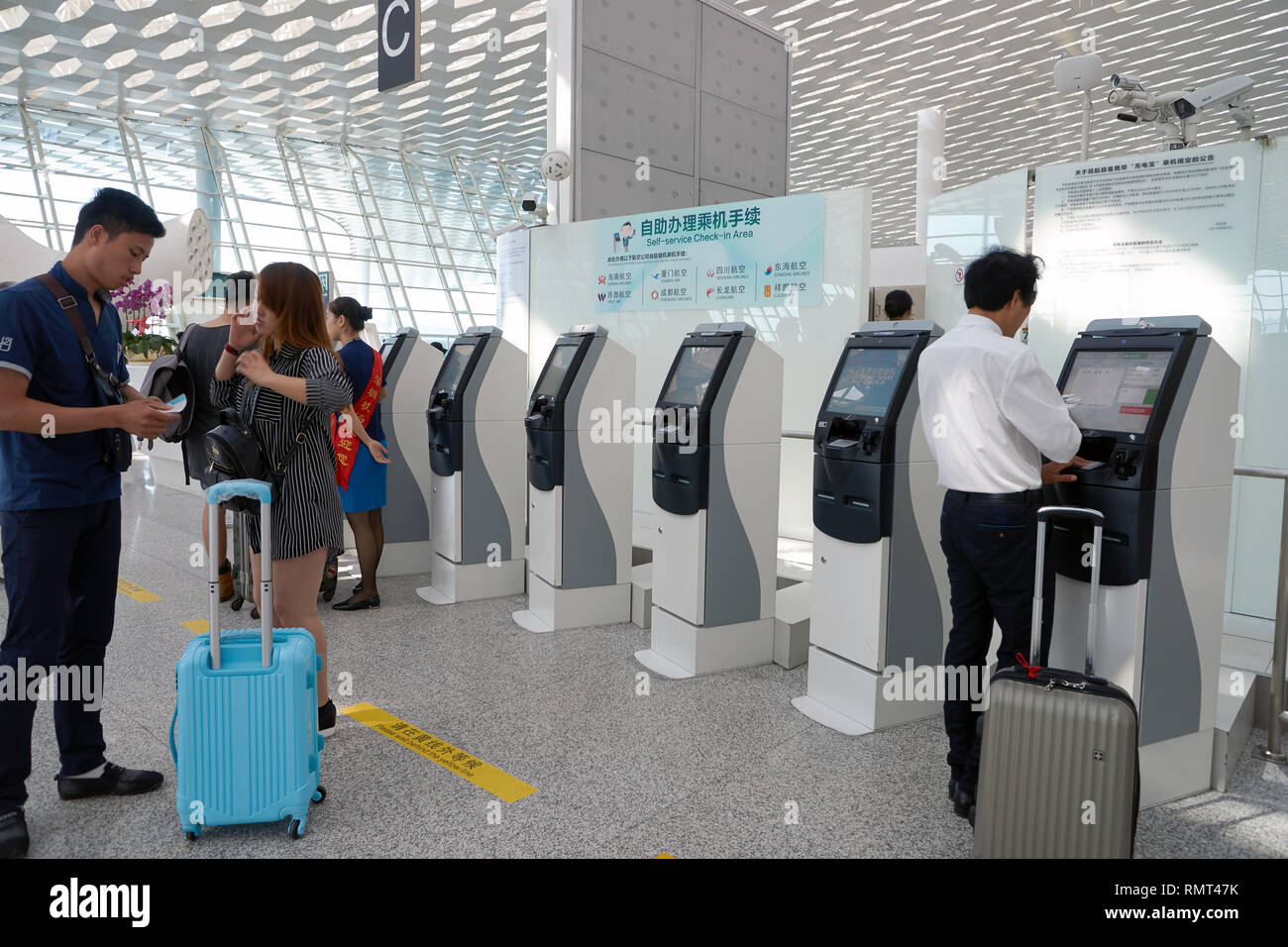SHENZHEN, CHINA - CIRCA MAY, 2016: man use self check-in kiosk in ...