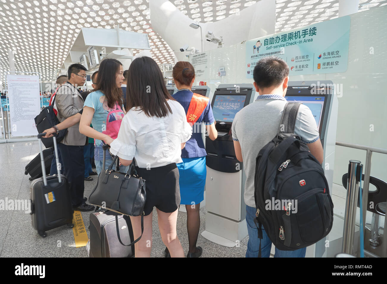 SHENZHEN, CHINA - CIRCA MAY, 2016: people use self check-in kiosks in ...