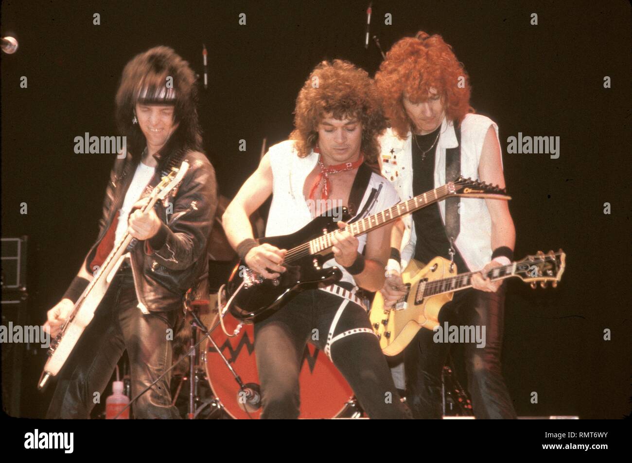 Autograph guitarist (name ?) is shown on stage performing "live" in ...