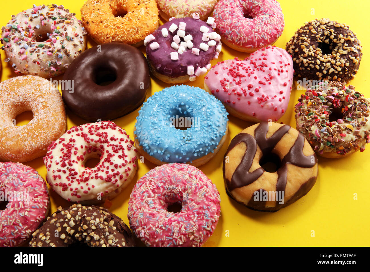 assorted donuts with chocolate frosted, pink glazed and sprinkles ...