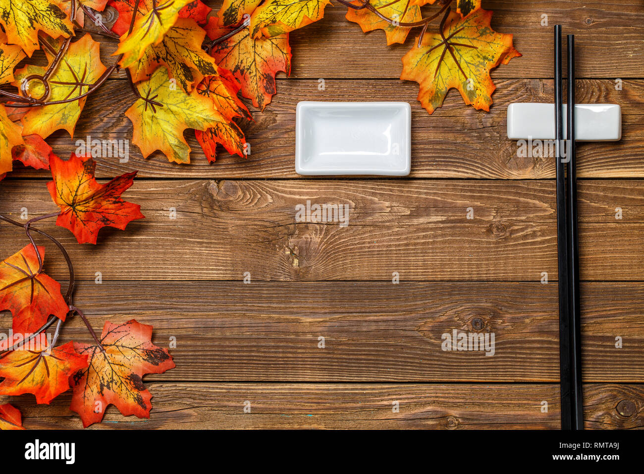 Wooden table with maple leaves Stock Photo - Alamy