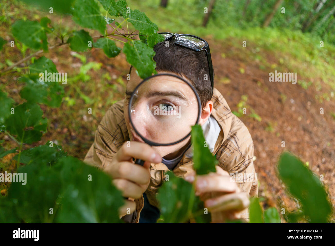 Picture of young ecologist with magnifying glass Stock Photo - Alamy