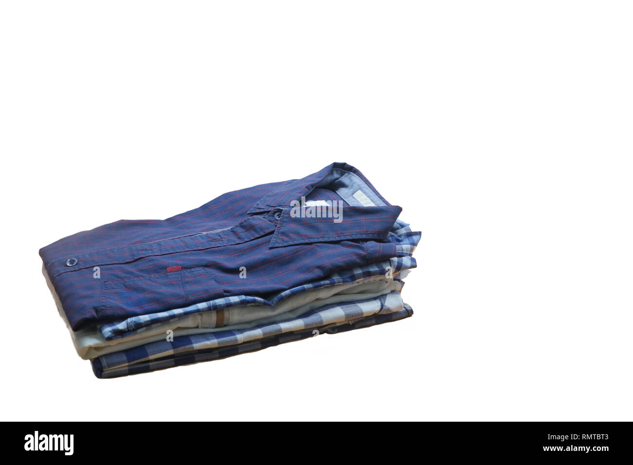 Stack of shirts isolated on white background Stock Photo - Alamy