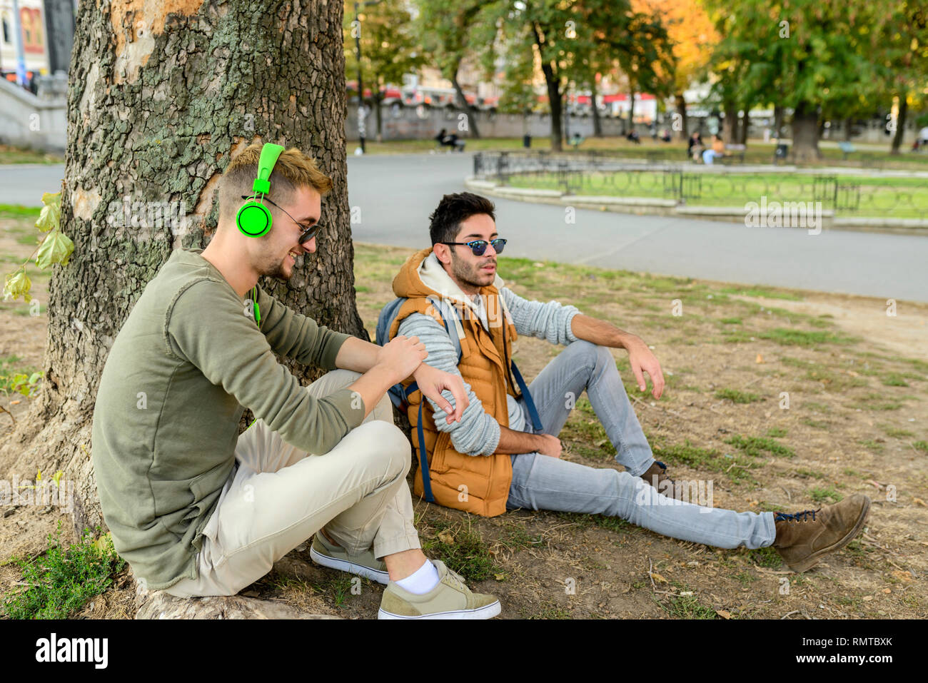 Two men sitting under tree hi-res stock photography and images - Alamy