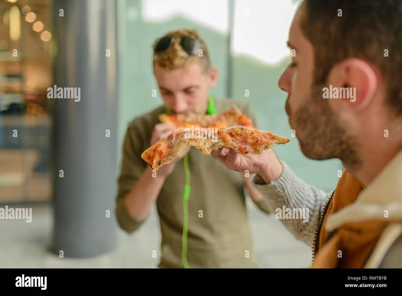 Two closed friends are enjoying a snack in the city street Stock Photo ...