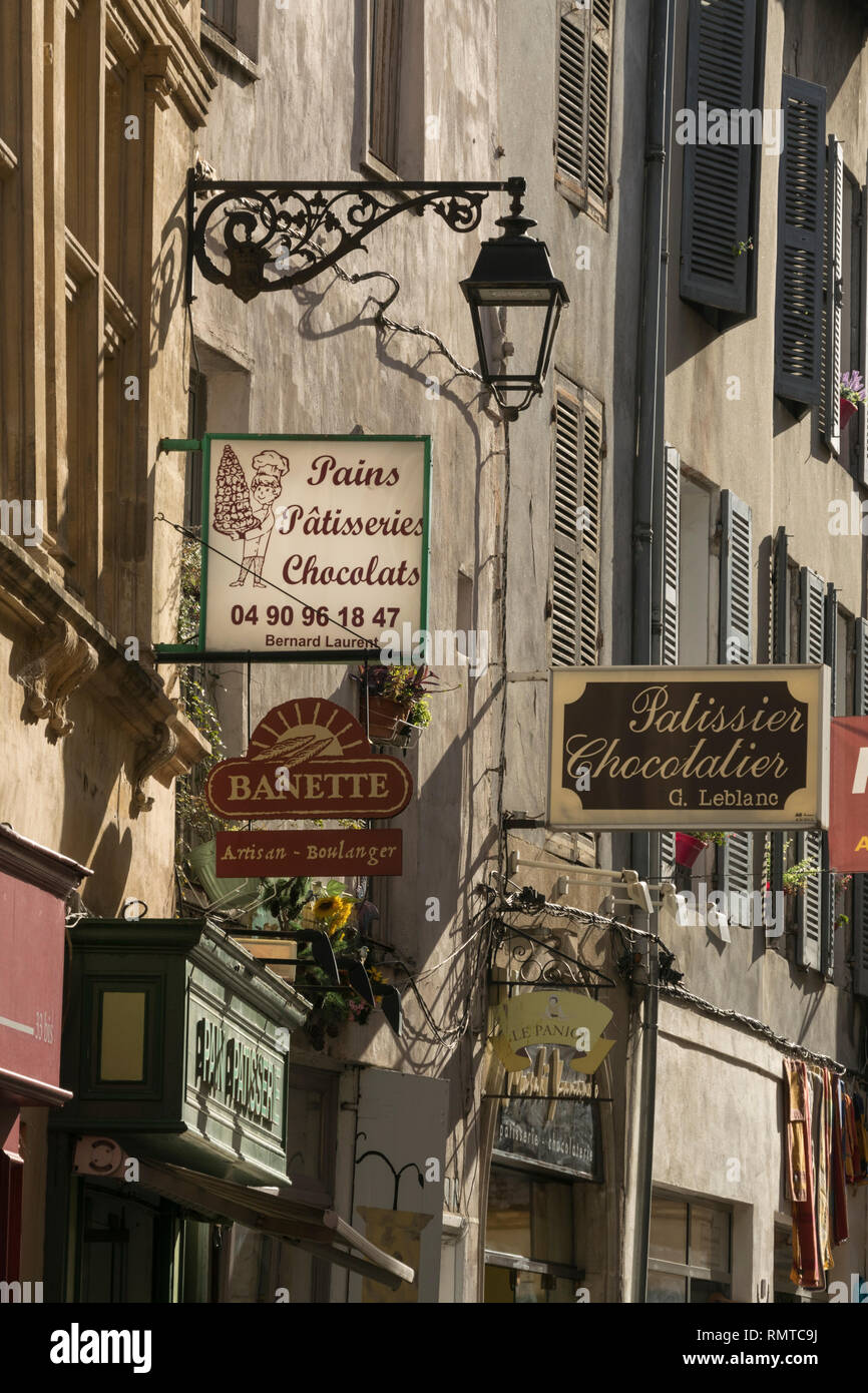 Traditional shop signs line the narrow streets of the provincial town ...