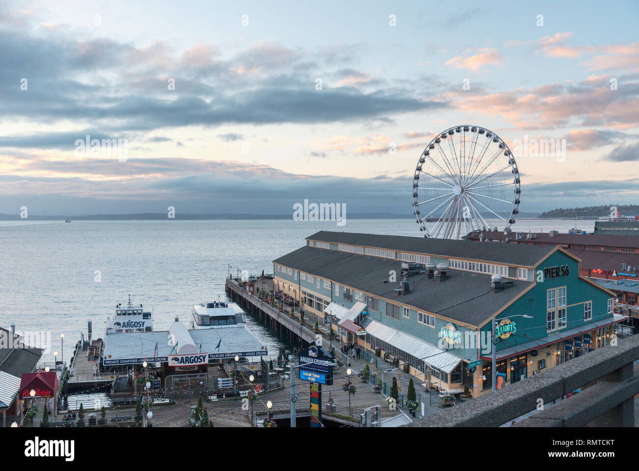 The Seattle downtown waterfront at dusk with the Ferris Wheel and ...
