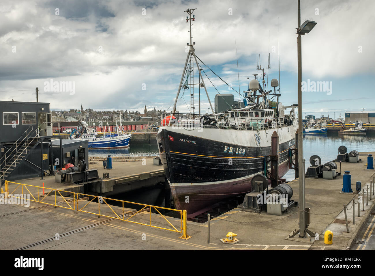 A fishing vessel being raised from the harbour using the ship-lift at ...