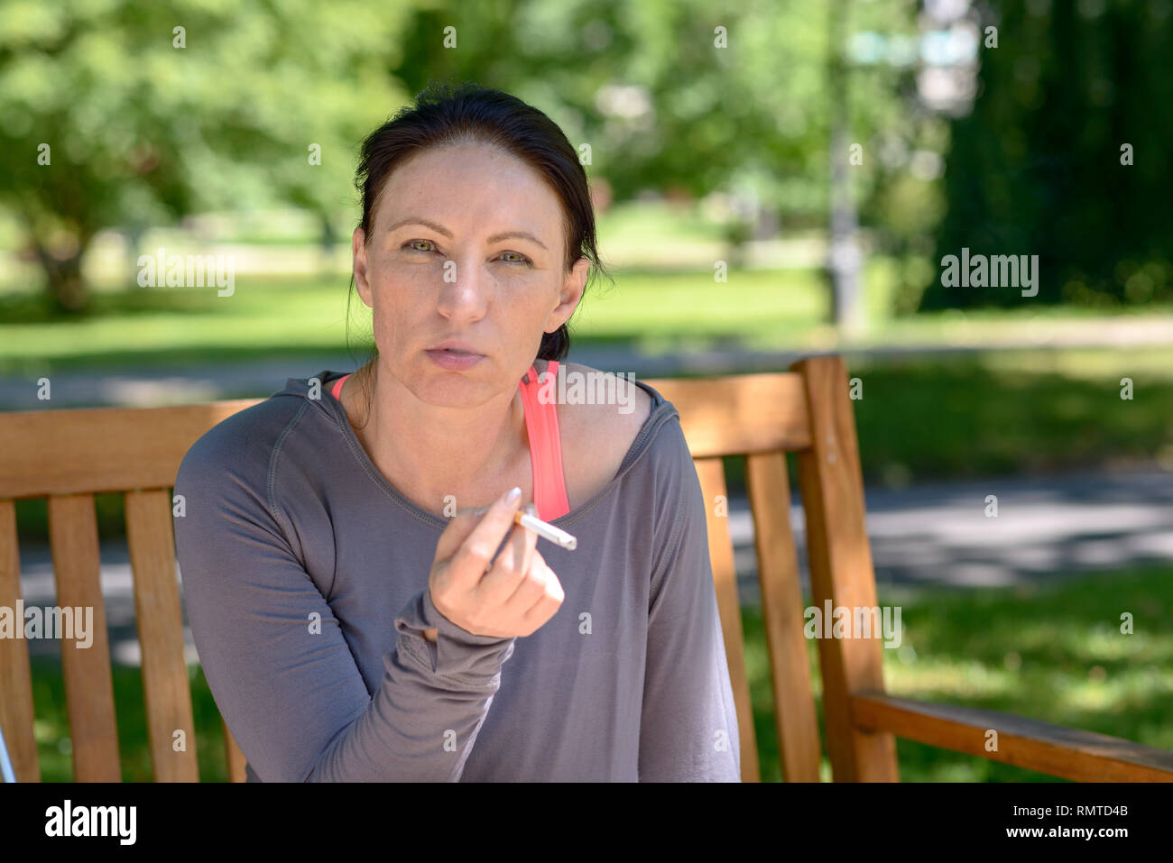 Middle aged woman smoking cigarette hi-res stock photography and images ...