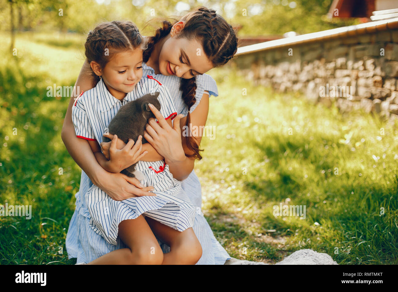 two beautiful girls with cats Stock Photo - Alamy