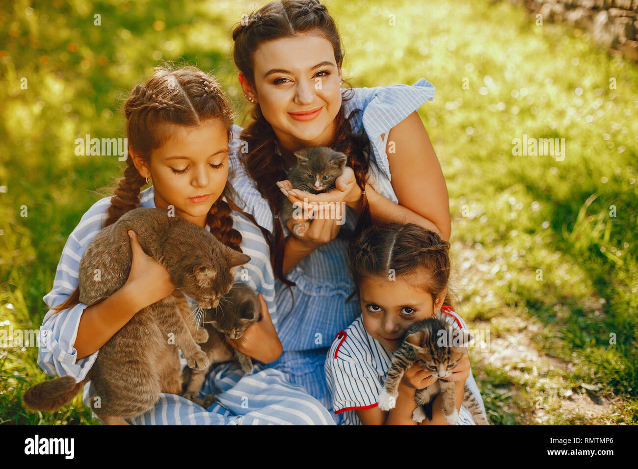 three beautiful girls with cats Stock Photo - Alamy