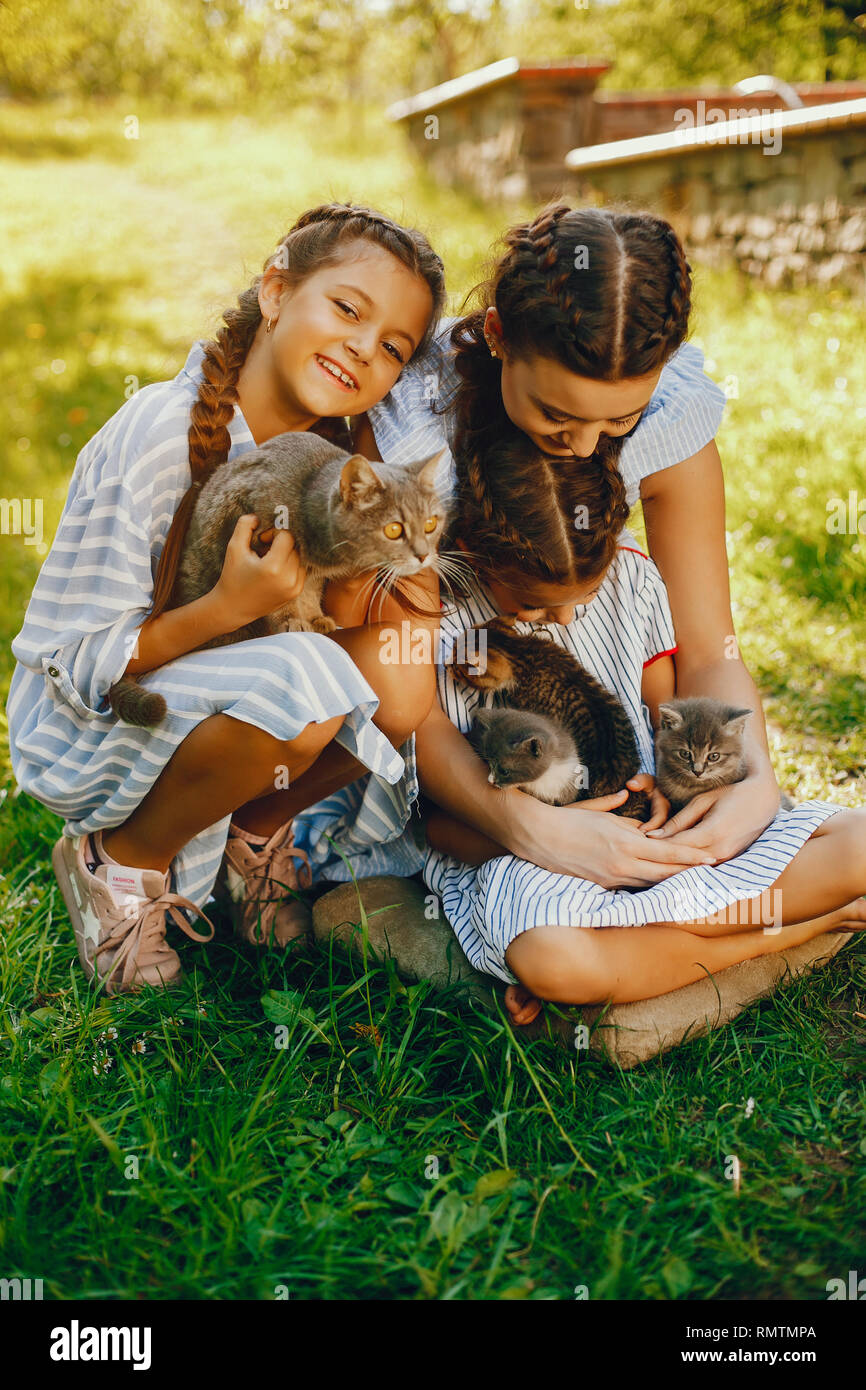 three beautiful girls with cats Stock Photo - Alamy