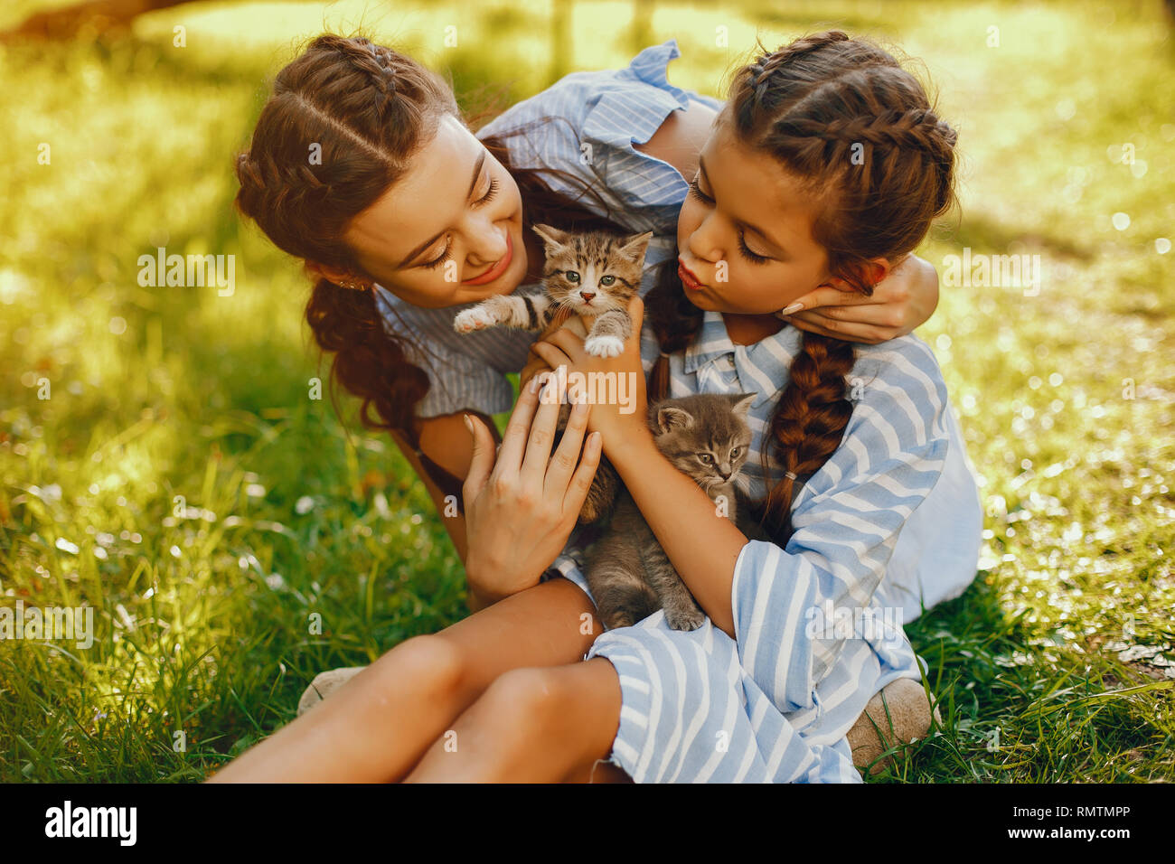 two beautiful girls with cats Stock Photo - Alamy