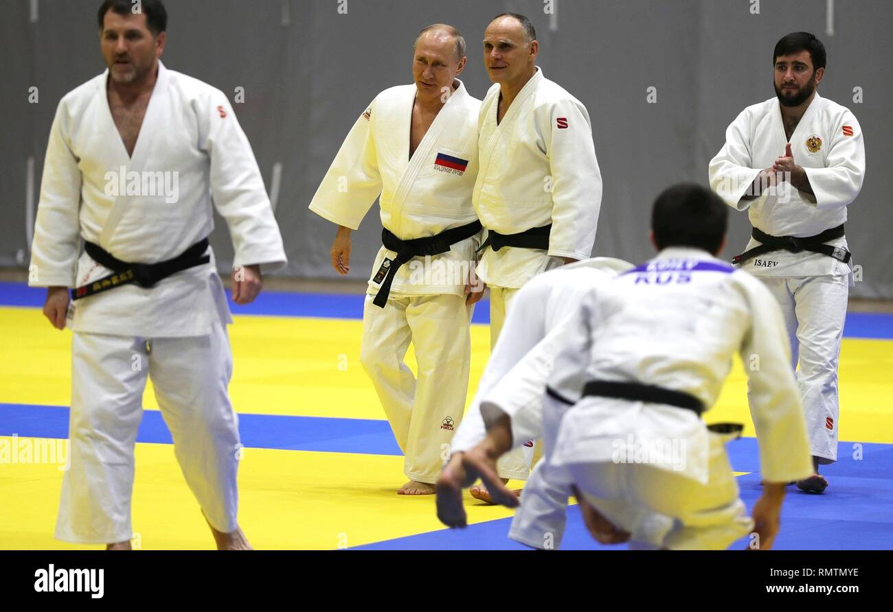 Russian President Vladimir Putin chats with the head coach of the ...