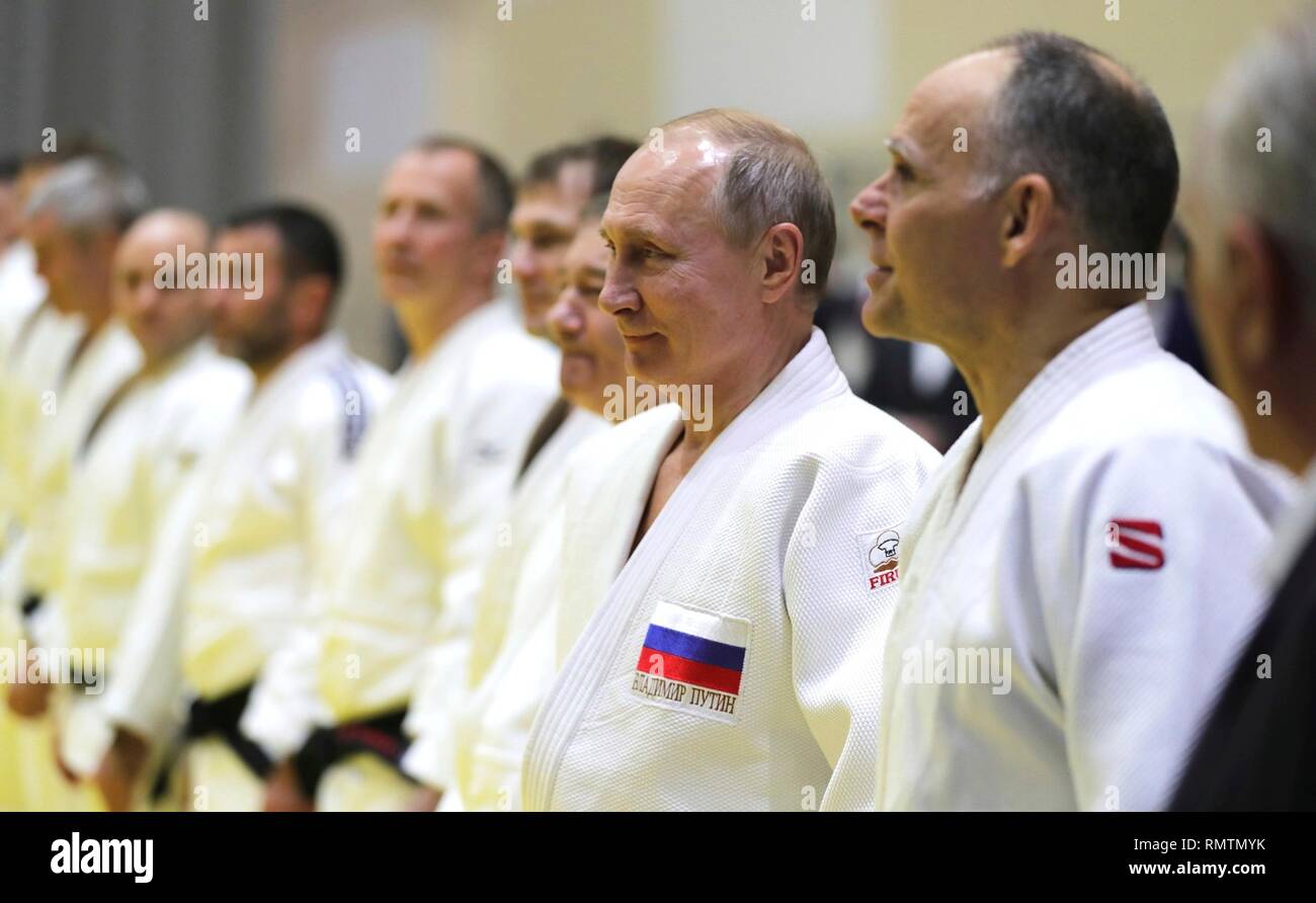 Russian President Vladimir Putin chats with the head coach of the ...