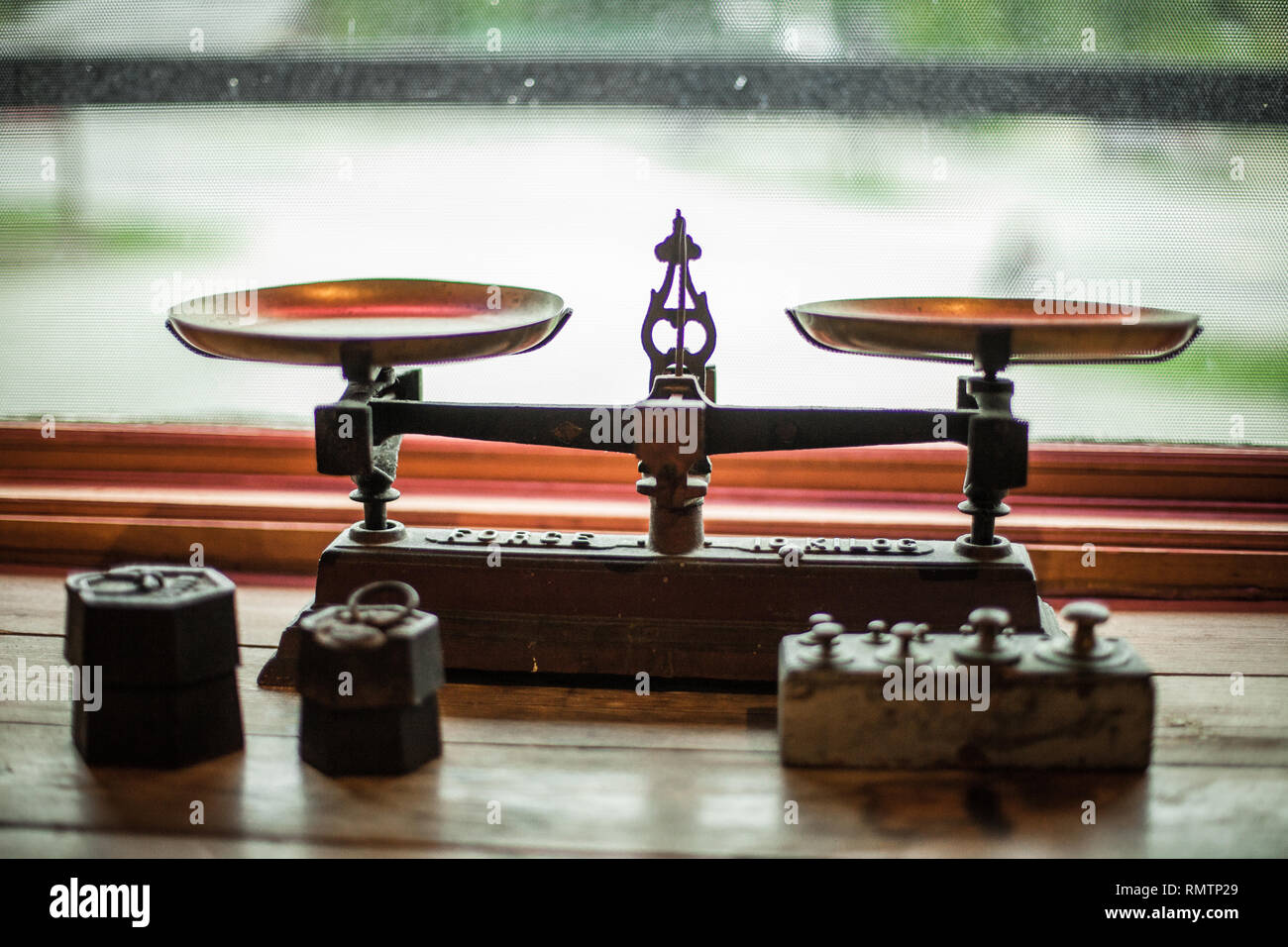 Old-school weighing balance with iron weights, pictured in front of a ...