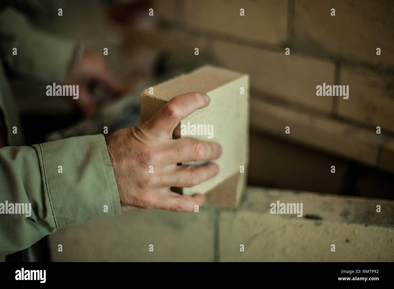 Bricklayer holding brick trowel hi-res stock photography and images - Alamy