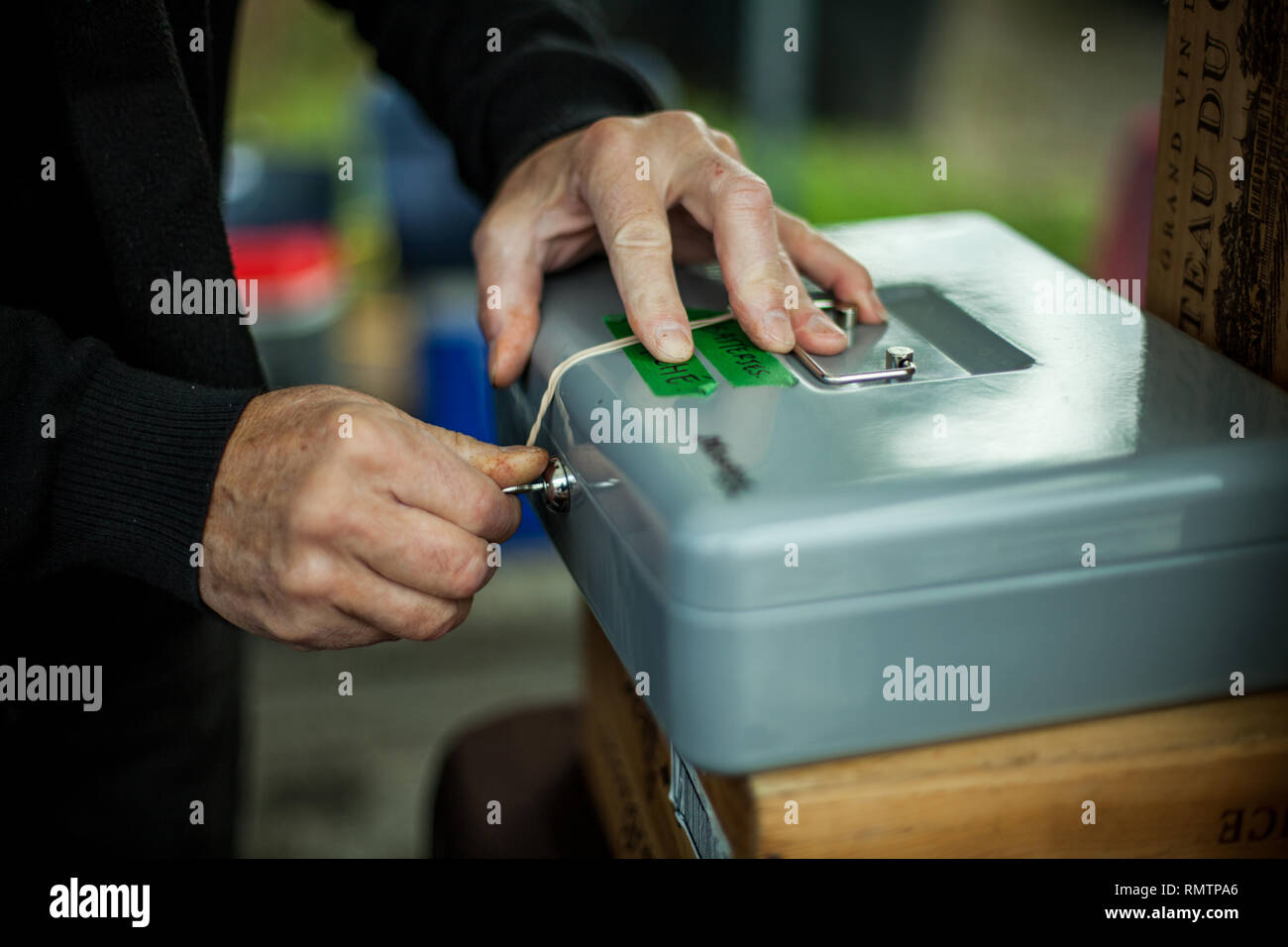 Hands locking a security box with a key Stock Photo - Alamy