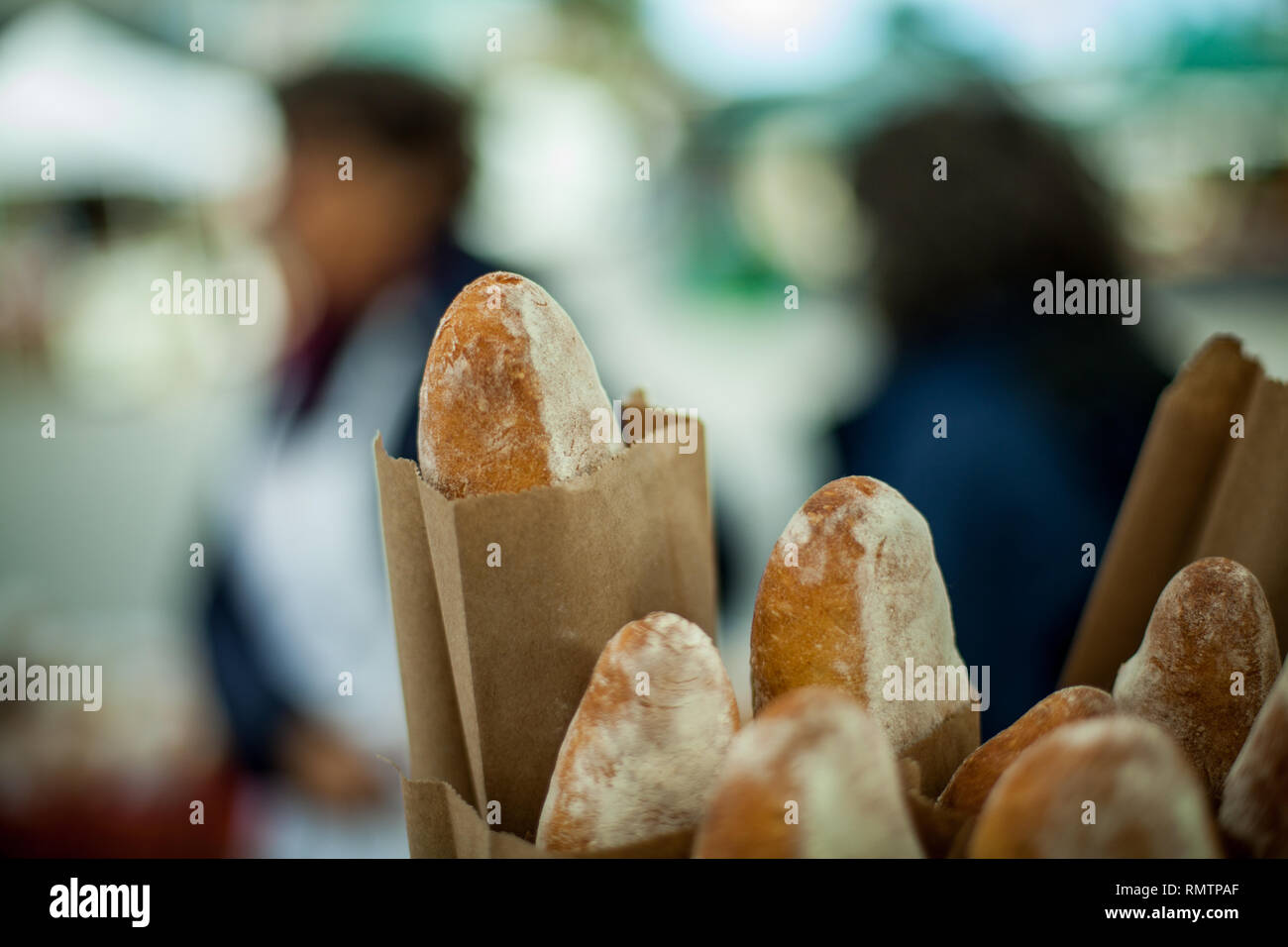 Baguette breads in paper bags at farmer's market Stock Photo - Alamy