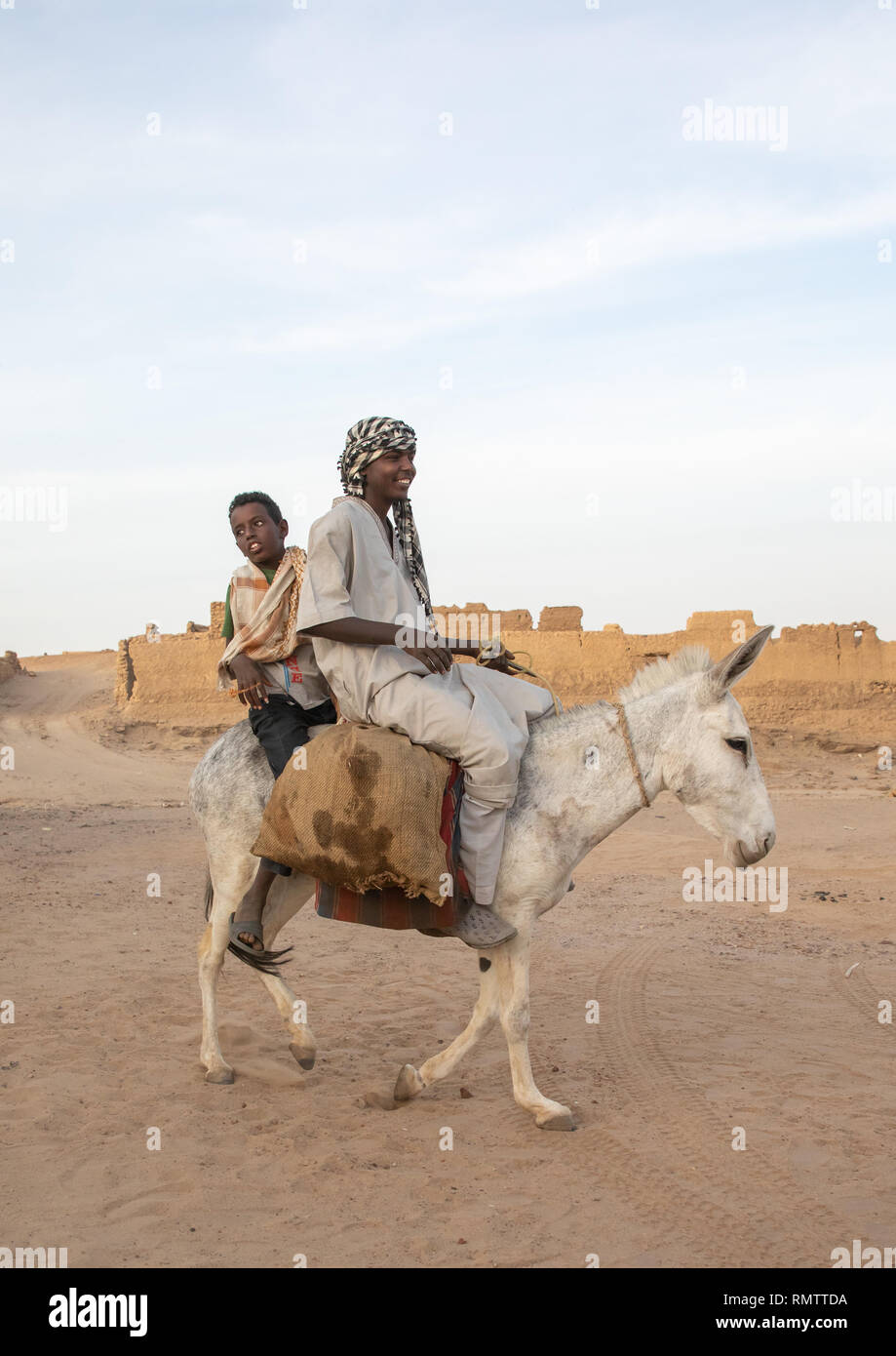 Sudanese men riding a donkey, Northern State, Al-Khandaq, Sudan Stock ...