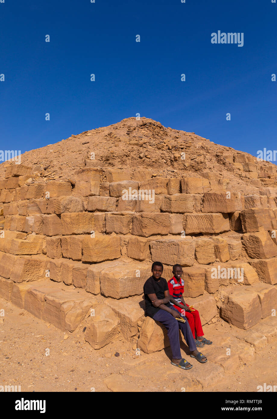 Sudanese children sit on a pyramid in the royal cemetery, Northern ...