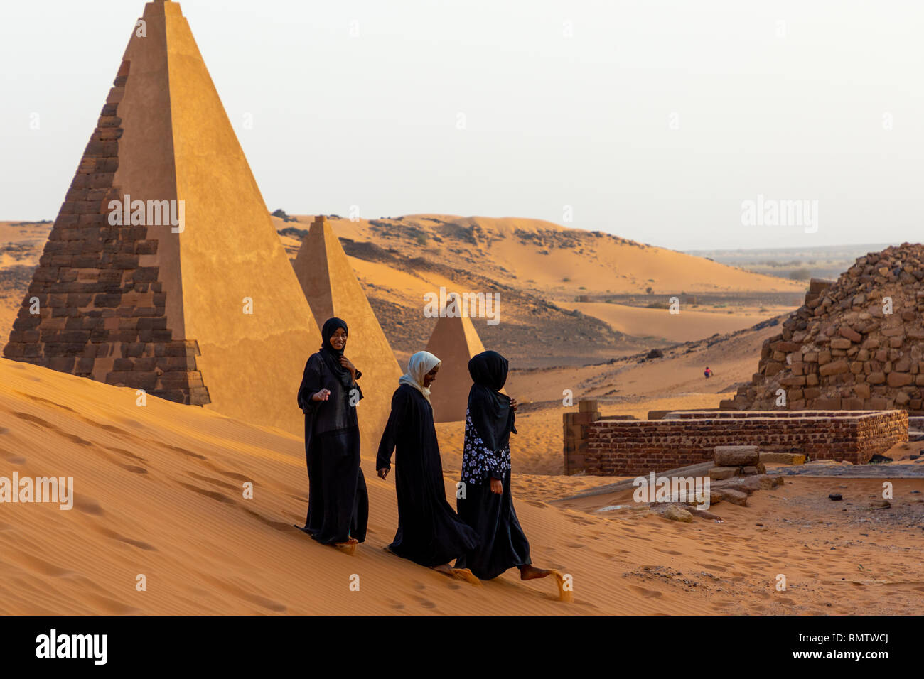 Sudanese women visiting the pyramids of the kushite rulers at Meroe ...