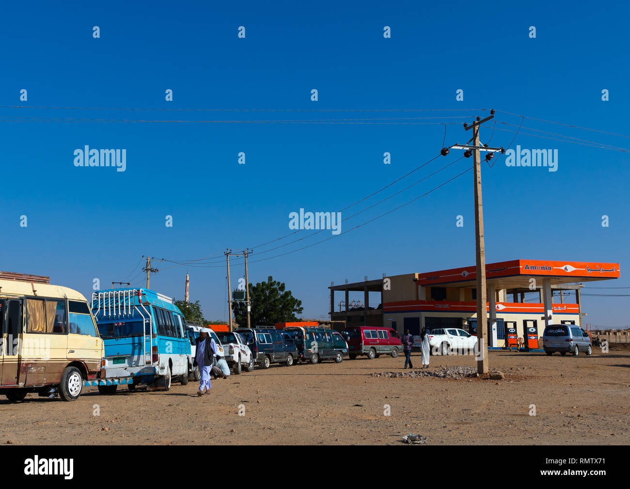Sudanese people in their cars queue on line at a gas station during the ...