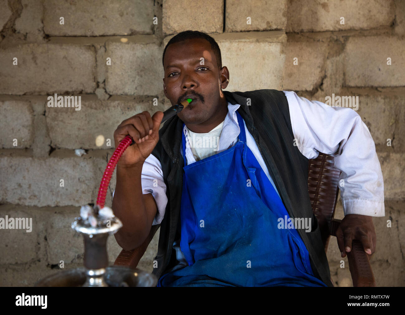 Beja man smoking water pipe, Red Sea State, Suakin, Sudan Stock Photo ...