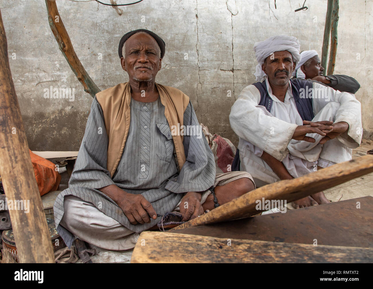 Portrait of Beja tribe men selling swords in the market, Red Sea State ...