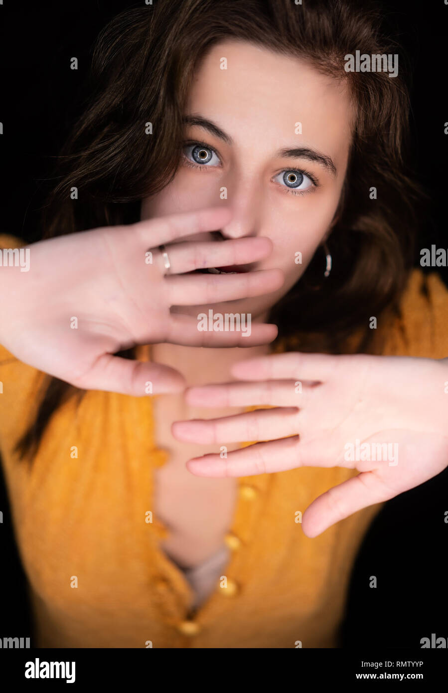Fear, Beautiful Young Woman posing on Black Background Stock Photo - Alamy