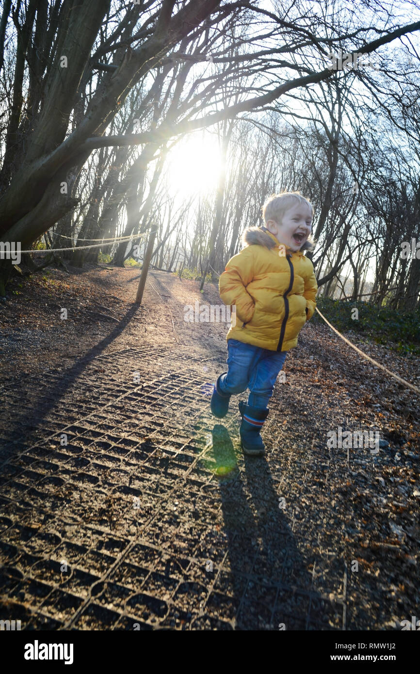 Boy playing outside in forest he is happy and carefree Stock Photo - Alamy