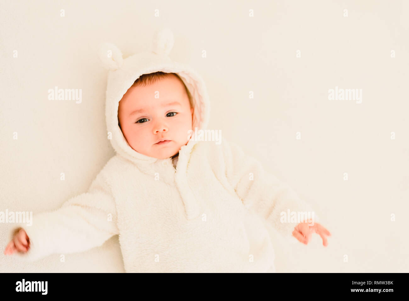 Beautiful baby girl resting on her back Stock Photo - Alamy