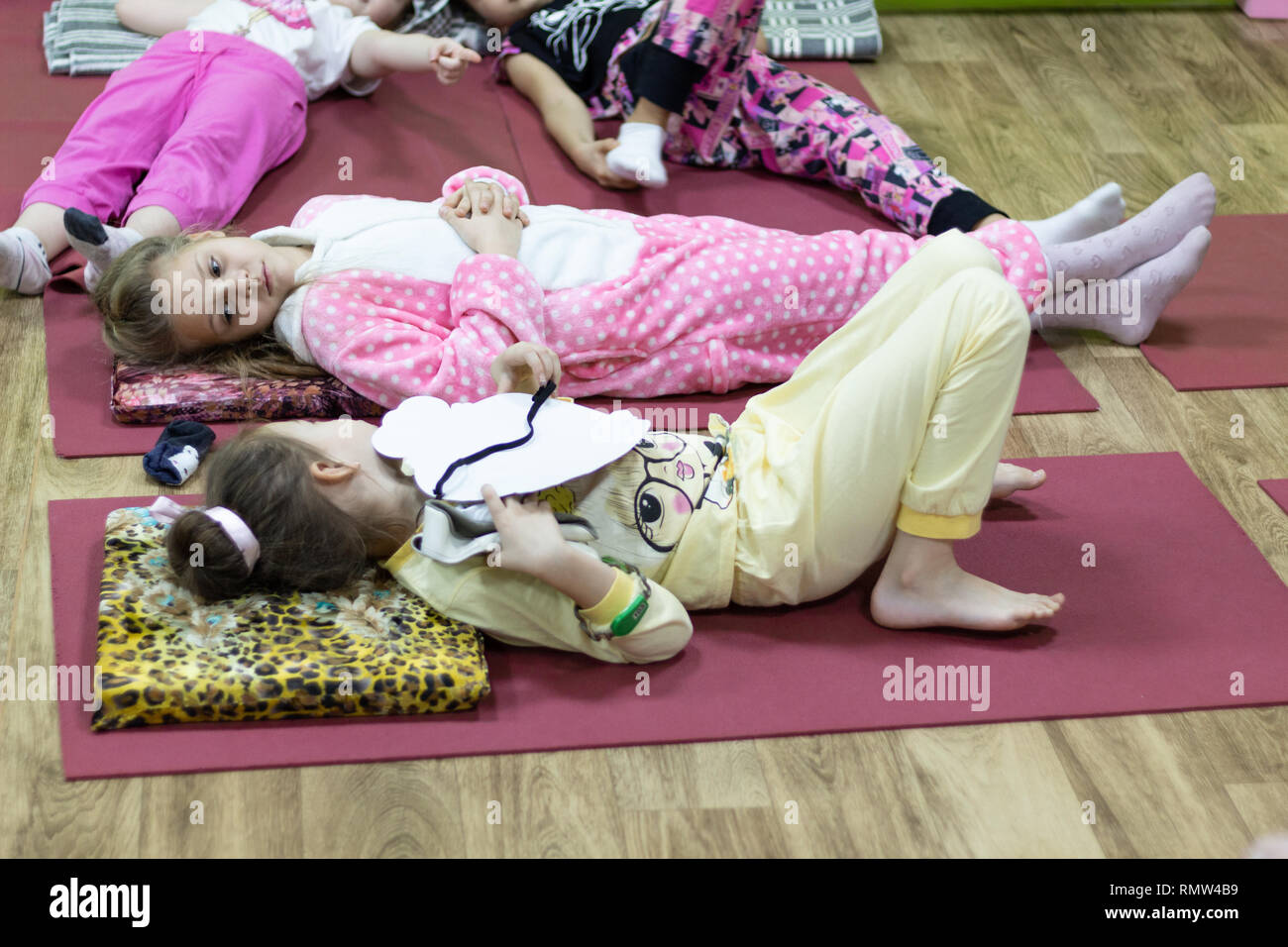 Children do yoga in pajamas with a professional teacher Stock Photo - Alamy