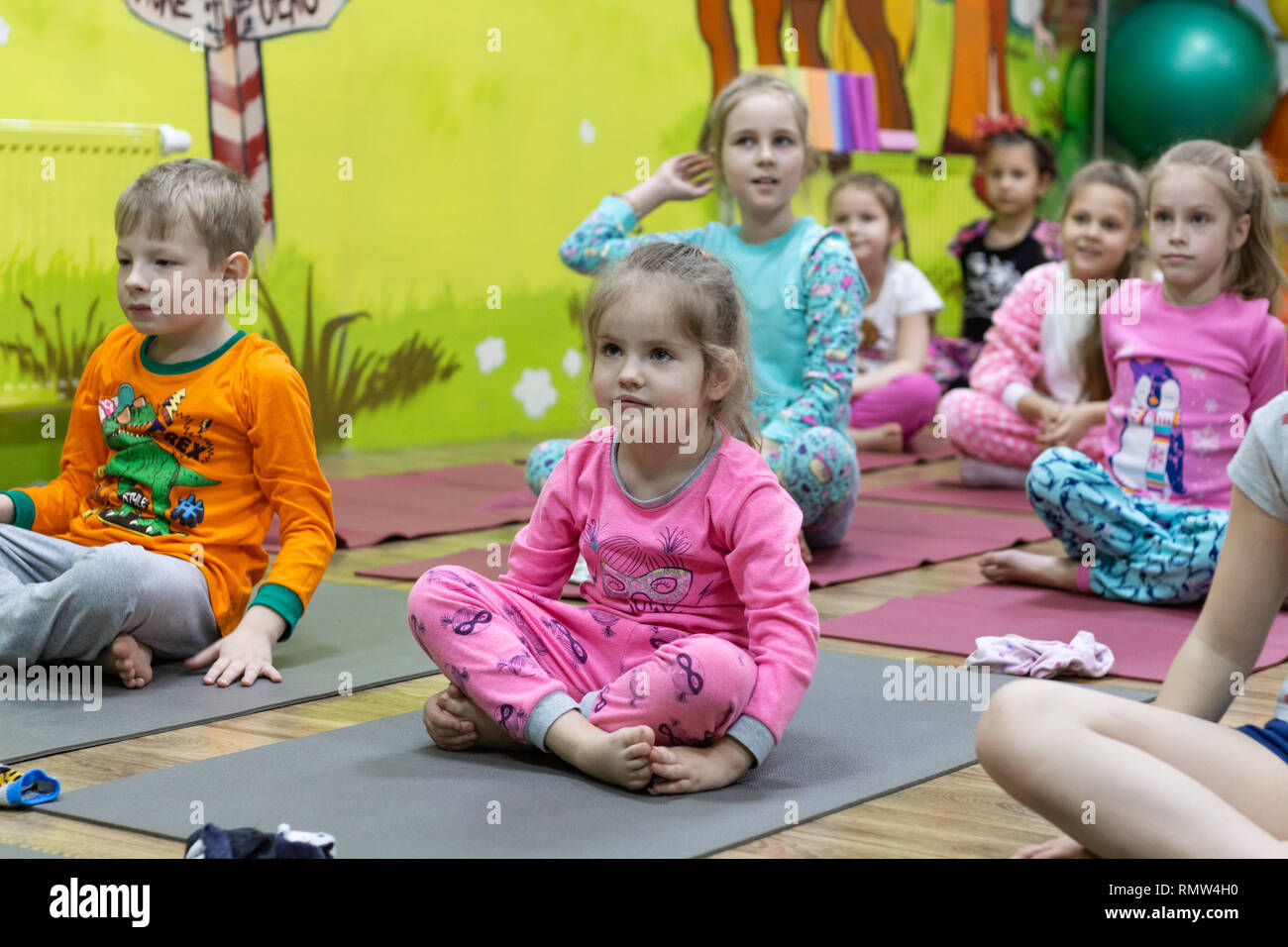 Children do yoga in pajamas with a professional teacher Stock Photo - Alamy