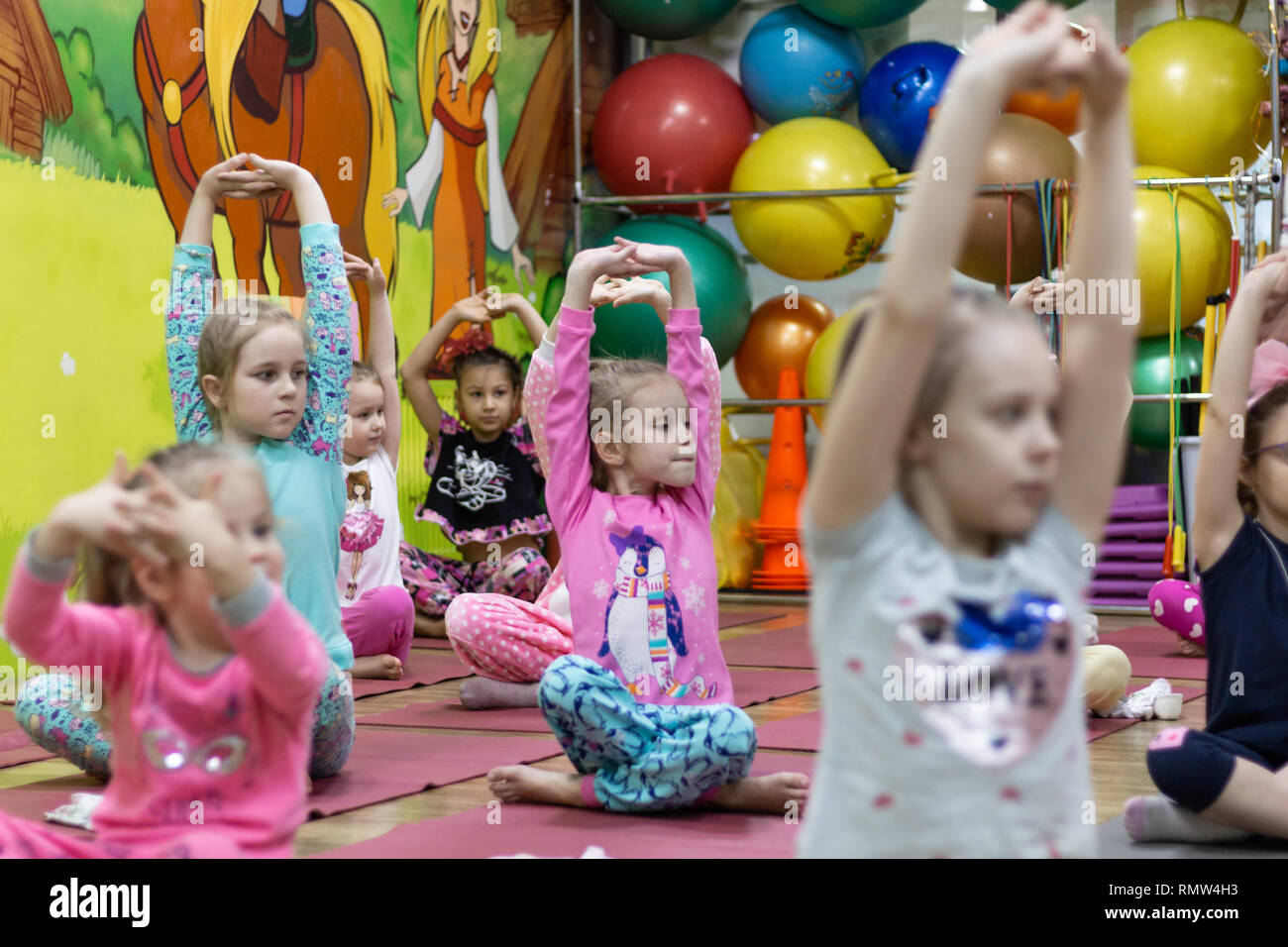 Children do yoga in pajamas with a professional teacher Stock Photo - Alamy