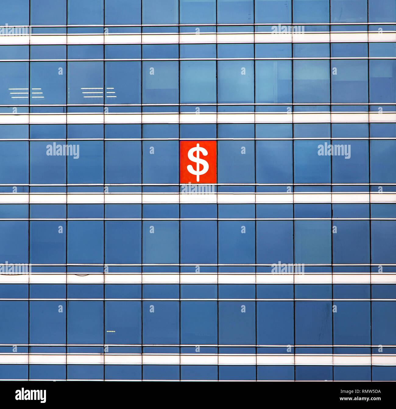 The symbol of the dollar currency on the building's window. The glass ...