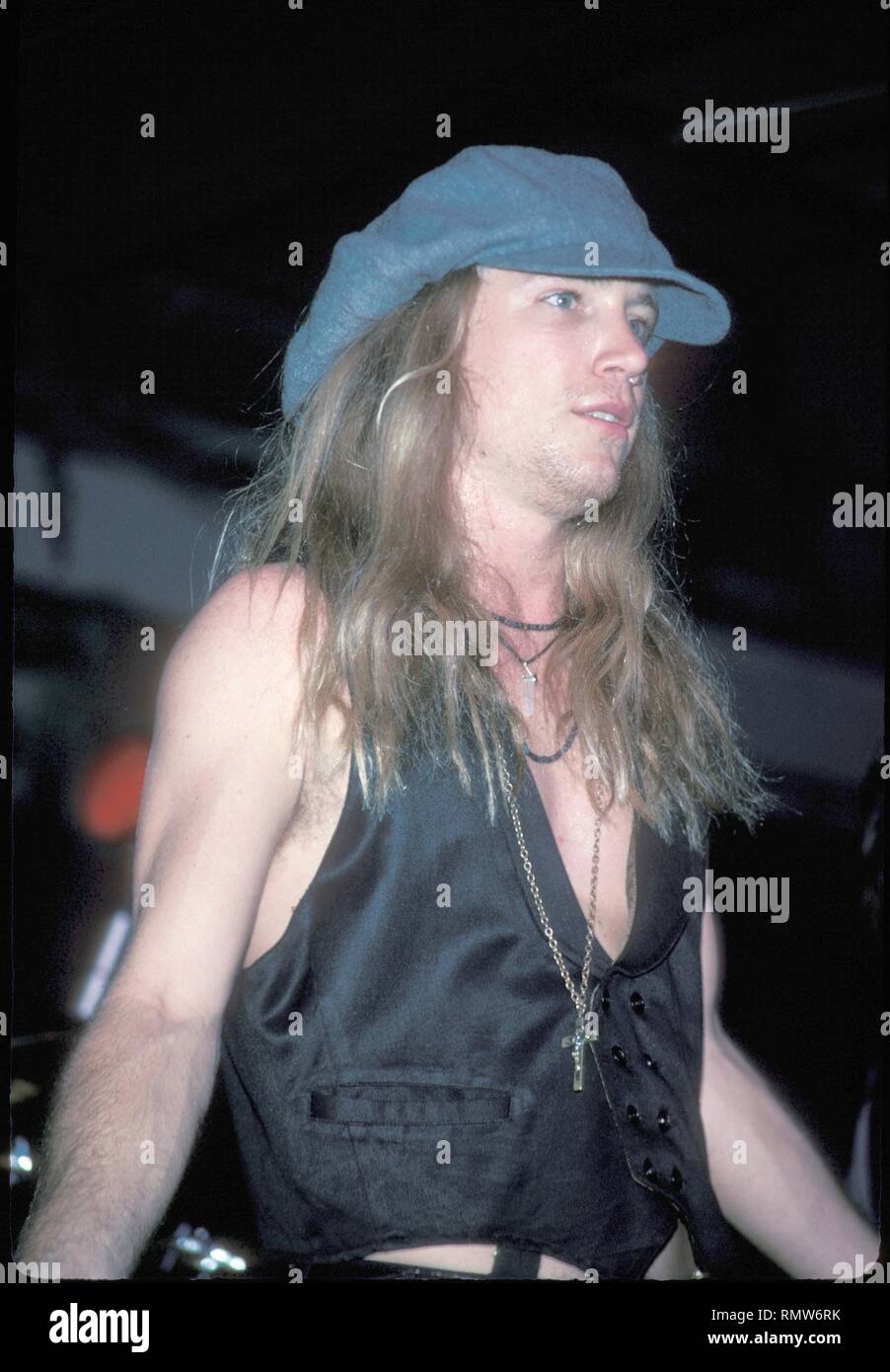 Lead singer and guitarist of The Poor Boys is shown performing on stage ...