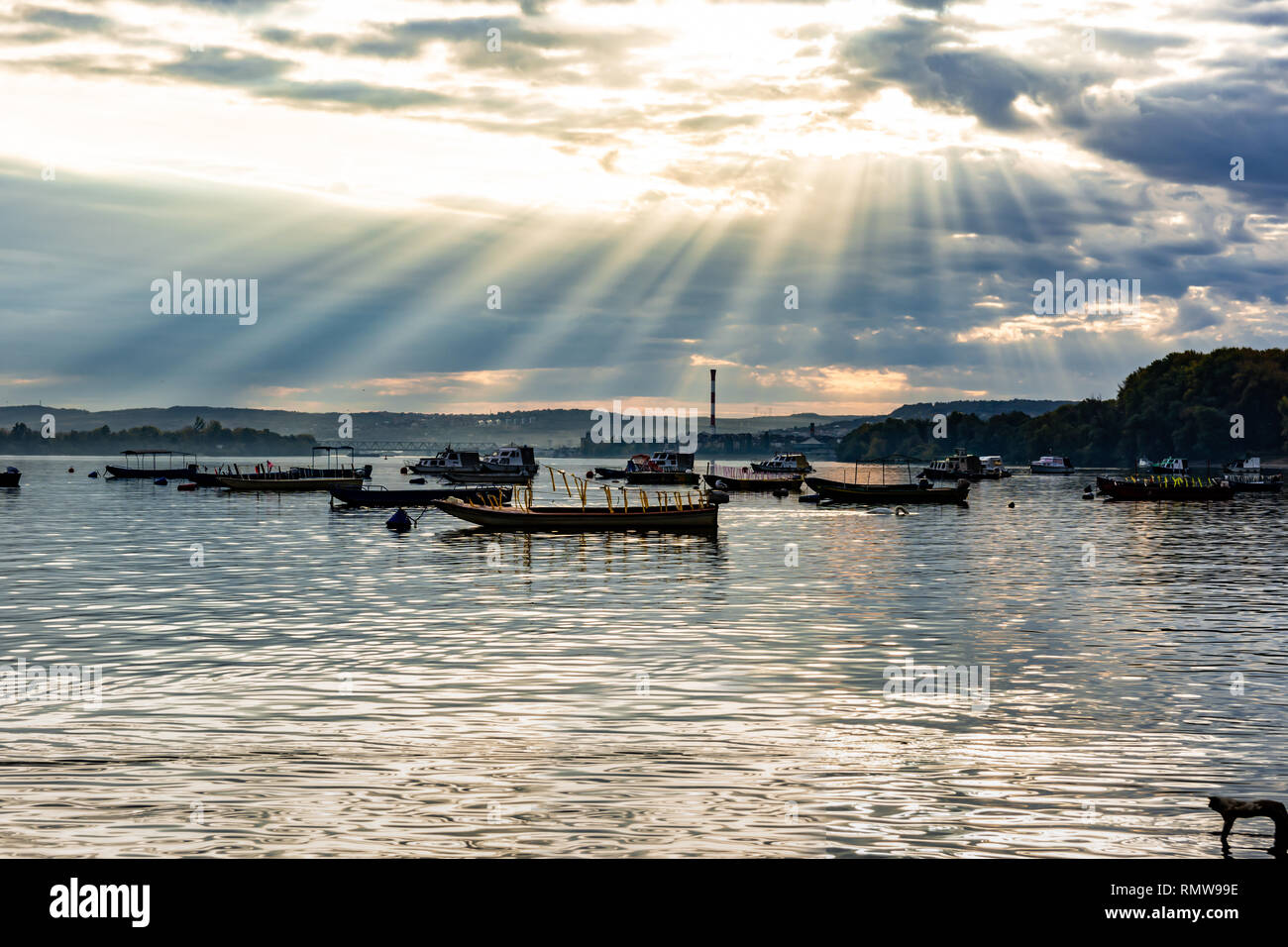 The morning sun's rays that pierce through the clouds, illuminate the ...