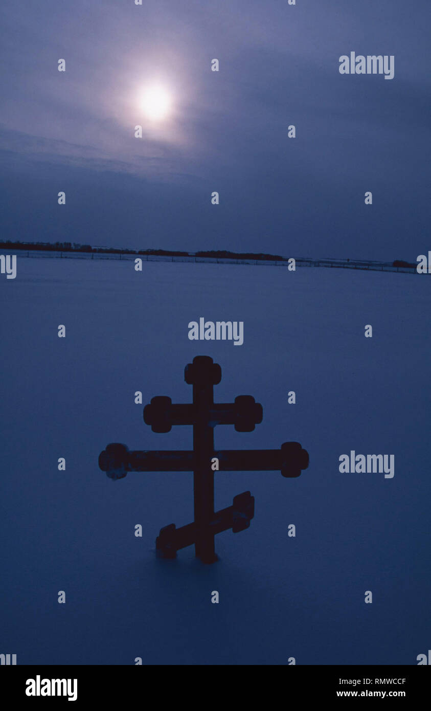 Ukrainian Orthodox cross on grave buried in the winter snow ...