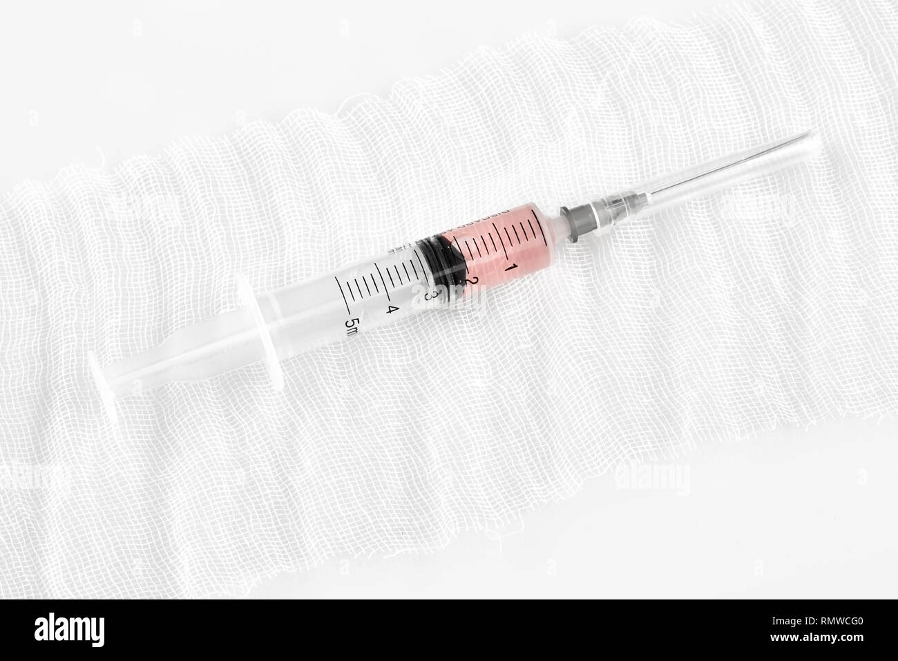 Syringe with pink medicine on white bandage Stock Photo - Alamy