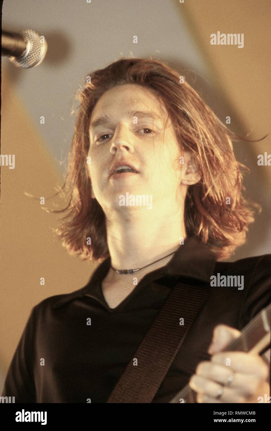 Lead singer and guitarist of the rock band Orbit is shown performing on ...