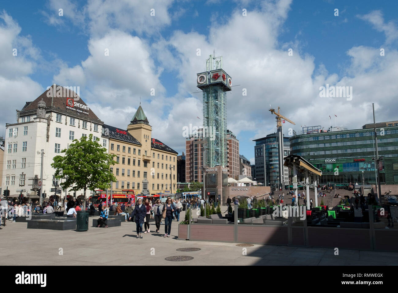 An urban plaza and clock tower by the train station in Oslo, Norway ...