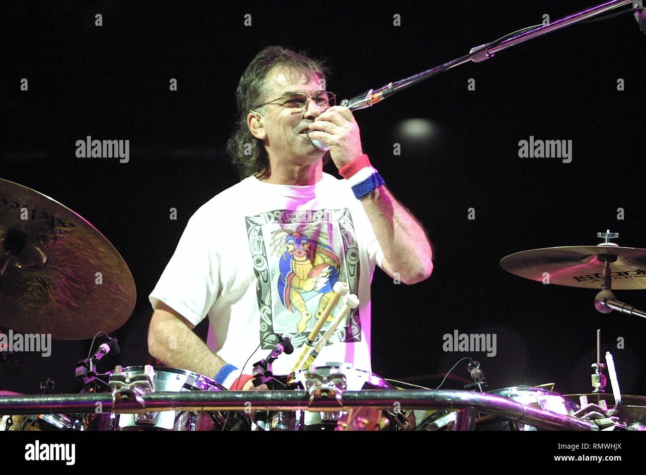 Drummer Mickey Hart of The Other Ones is shown performing on stage ...