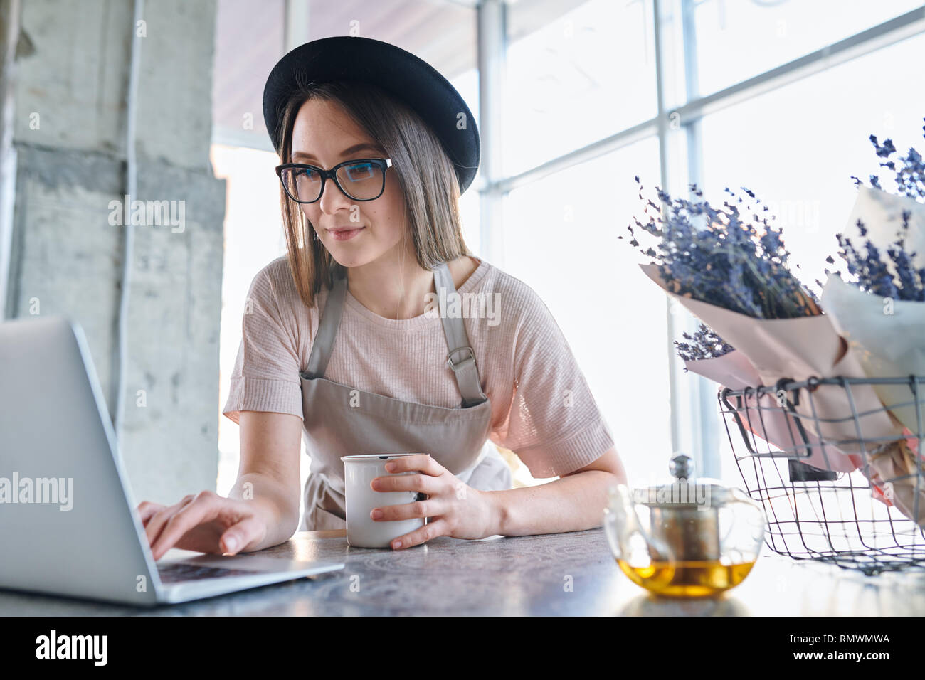 Woman bending over table hi-res stock photography and images - Alamy