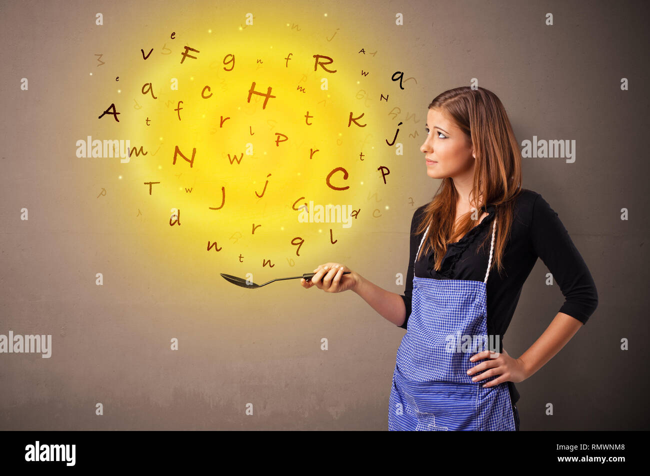 Young person cooking letters in wok Stock Photo - Alamy