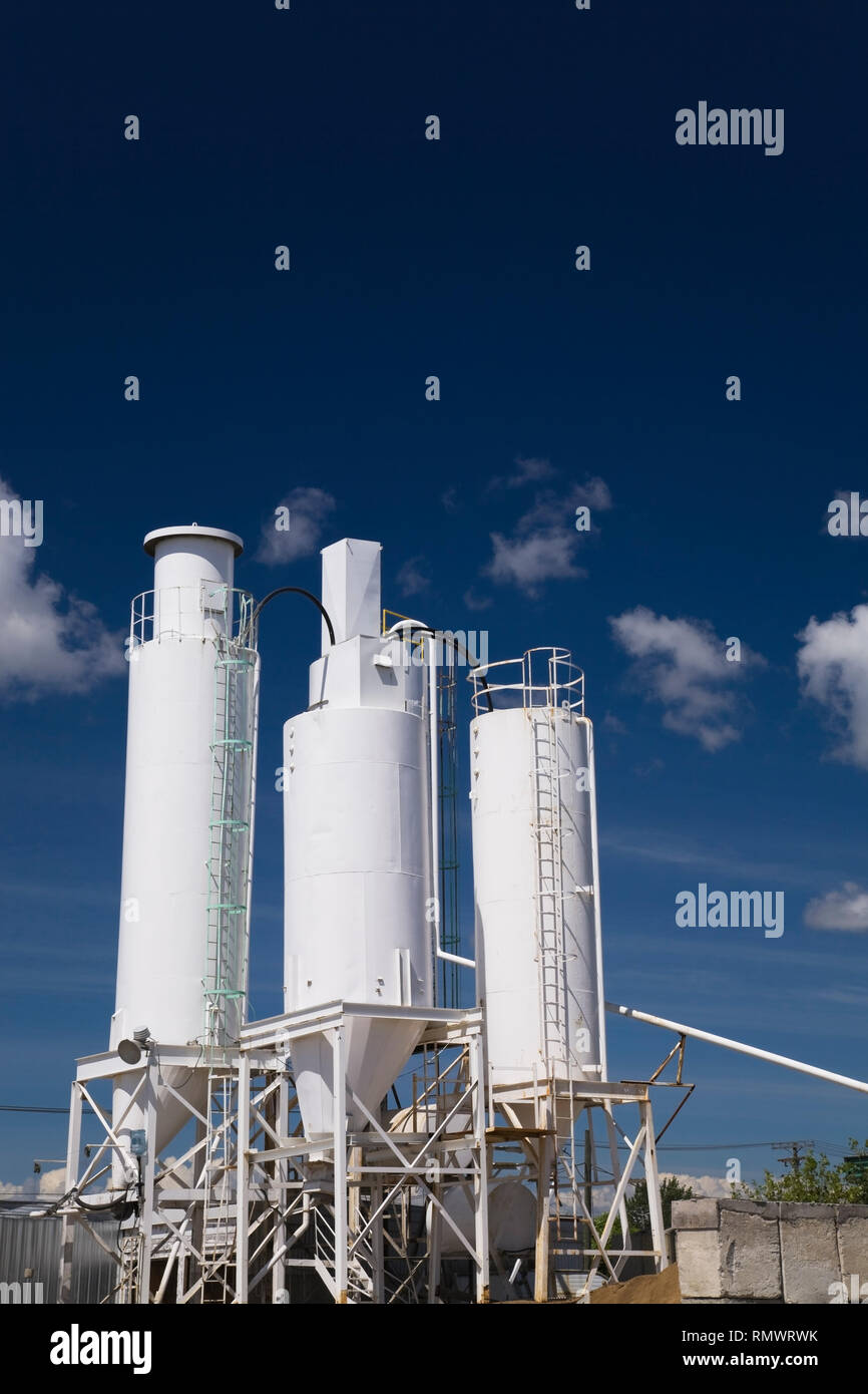 Industrial cement mixing, storage and distribution tanks at a cement ...