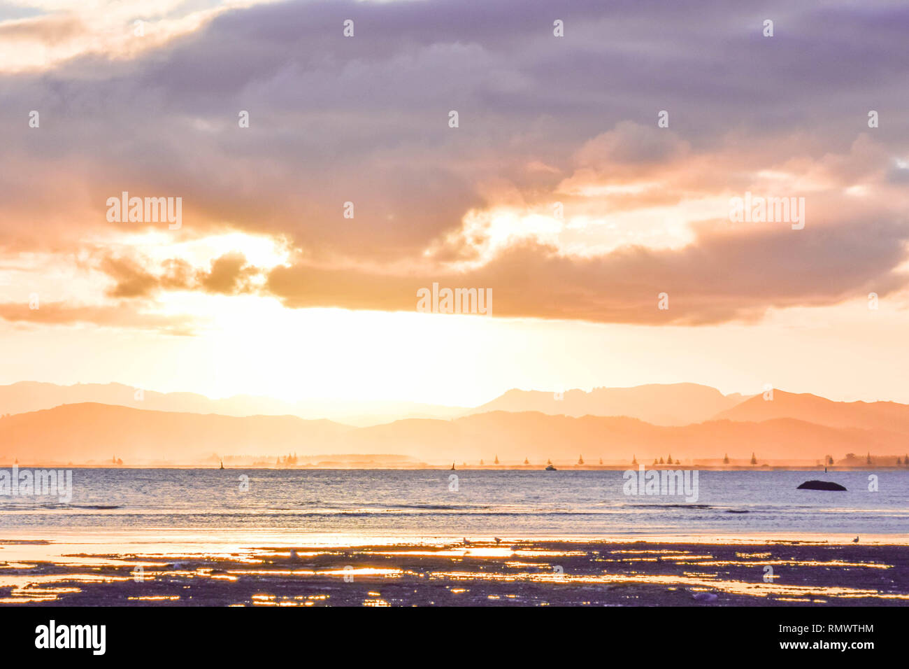The rock pools reflect the sky above Gisborne, New Zealand Stock Photo ...