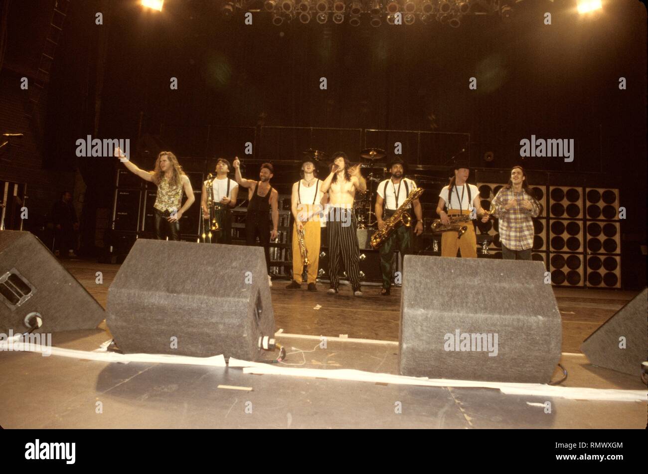 Extreme band members are shown on stage during a "live" concert ...